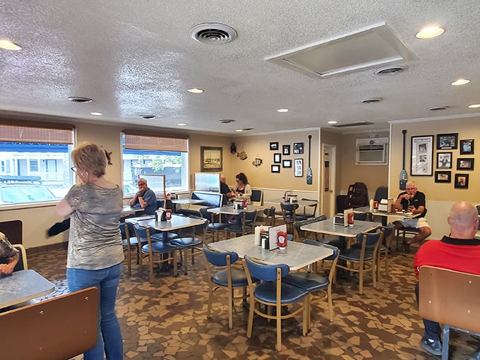 Inside, the no-nonsense dining room feels like a maritime family reunion. Those blue chairs have held generations of seafood enthusiasts mid-culinary revelation.