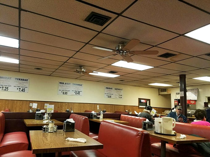 Red vinyl booths and wood-paneled walls aren't trendy; they're timeless. This dining room has witnessed more honest conversations than a therapist's office.