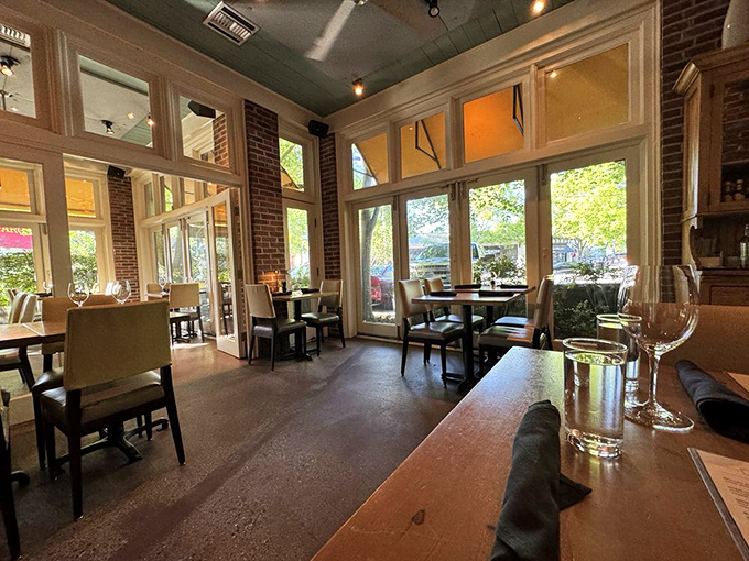 Sunlight streams through tall windows, illuminating a dining room where exposed brick meets elegant simplicity—the perfect backdrop for brunch revelations.