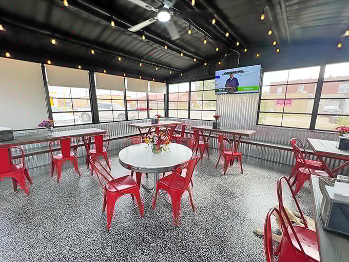 The covered patio offers a modern twist on diner dining, with string lights and red metal chairs creating an atmosphere that's both retro and refreshing.