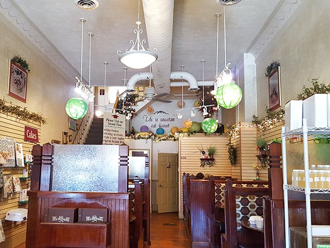 Step inside to a world where hanging lanterns cast a warm glow over wooden booths. That French quote on the wall? It translates to "Life is uncertain, eat dessert first."