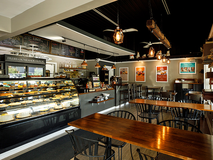 Inside this temple of temptation, pendant lights cast a warm glow over wooden tables where life-changing decisions happen daily: apple pie or cherry? Why not both?