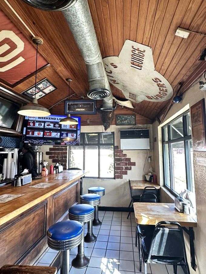 Inside, every inch tells a story&mdash;wood-paneled ceilings, blue counter stools, and just enough room to witness burger artistry in action.