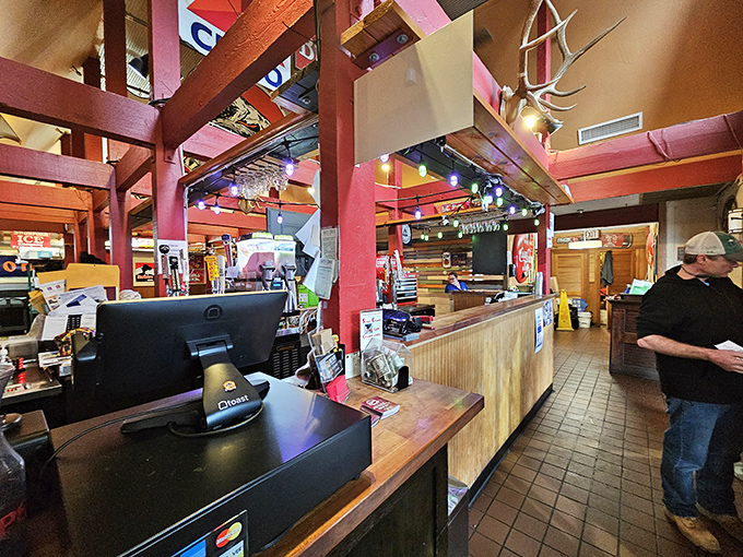 Where burger magic happens. The warm wooden beams and rustic counter create that perfect small-town atmosphere where everyone feels like a regular.