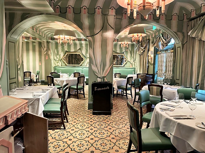Step into this mint-green striped dining room where chandeliers and curved archways create an atmosphere that whispers, "Your diet starts tomorrow, darling."