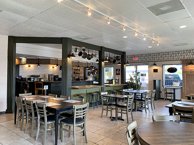 Where magic happens! The open kitchen design lets you witness the culinary choreography while hanging pots promise homestyle cooking that doesn't cut corners.