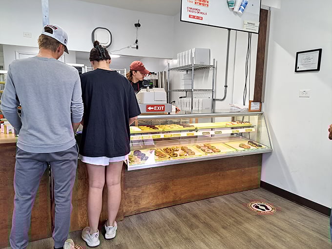 The morning pilgrimage in progress. Like watching a religious experience unfold&mdash;customers contemplating life's most important question: "Which donut speaks to my soul today?"
