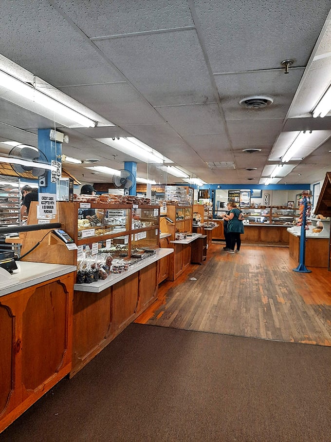 Wooden display cases stretch into chocolate infinity. The warm hardwood floors have witnessed countless sugar-induced grins and the birth of family traditions.