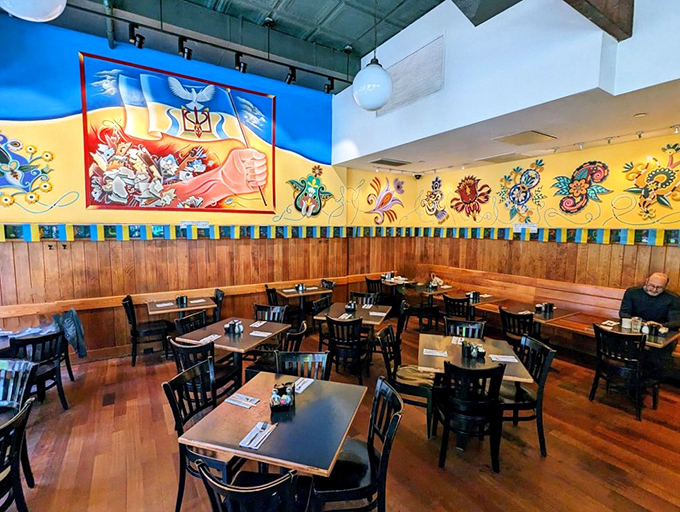 Colorful Ukrainian folk art adorns walls above wooden booths, creating the perfect backdrop for comfort food conversations and coffee-fueled New York moments.