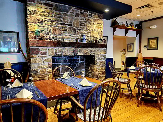 The stone fireplace isn't just for show&mdash;it's the beating heart of this dining room where Windsor chairs and wooden tables have witnessed countless "I can't believe how good this is" moments.