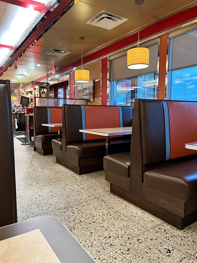 Sliding into these vinyl booths feels like time travel with better upholstery. The red and blue color scheme practically whispers "order the meatloaf."