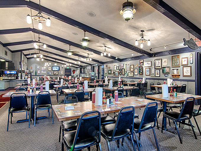 Wooden beams, nautical lighting, and walls adorned with fishing memorabilia create the perfect backdrop for the serious business of catfish consumption.