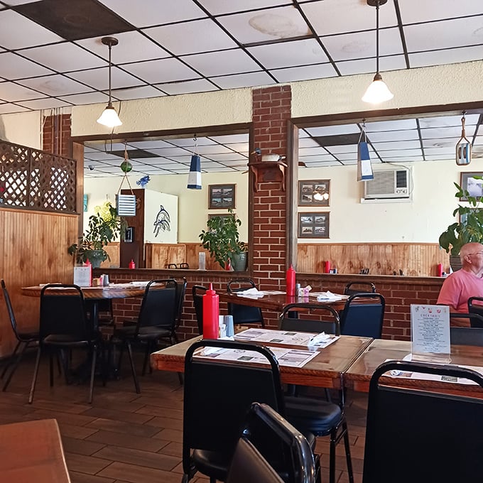 Wood paneling, brick columns, and no-nonsense tables create that rare atmosphere where both fishermen and foodies feel equally at home.