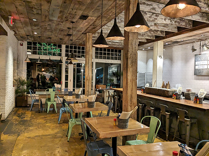 Rustic-meets-refined interior with weathered wood beams and white brick walls creates the perfect backdrop for your seafood adventure. 