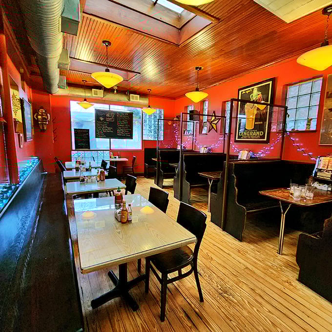 Retro vibes meet modern culinary sensibilities in this cozy interior. The warm wooden ceiling and fiery red walls create an atmosphere that's equal parts nostalgic and energizing.