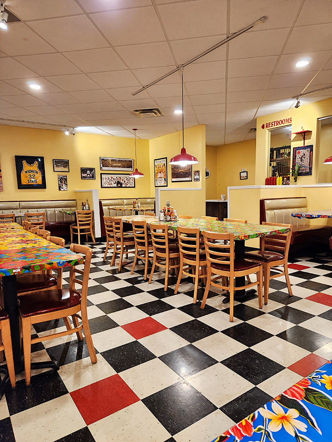 Classic checkered floors meet sunny yellow walls in this diner where every table tells a story and every booth holds a promise.