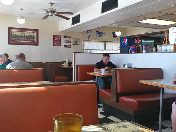 Red vinyl booths and checkerboard floors – the universal language of "good food served here." This isn't décor; it's a time machine to simpler days.