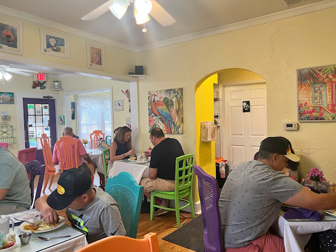 Inside, a kaleidoscope of colorful chairs creates the feeling you've wandered into an artist's breakfast nook rather than a restaurant.
