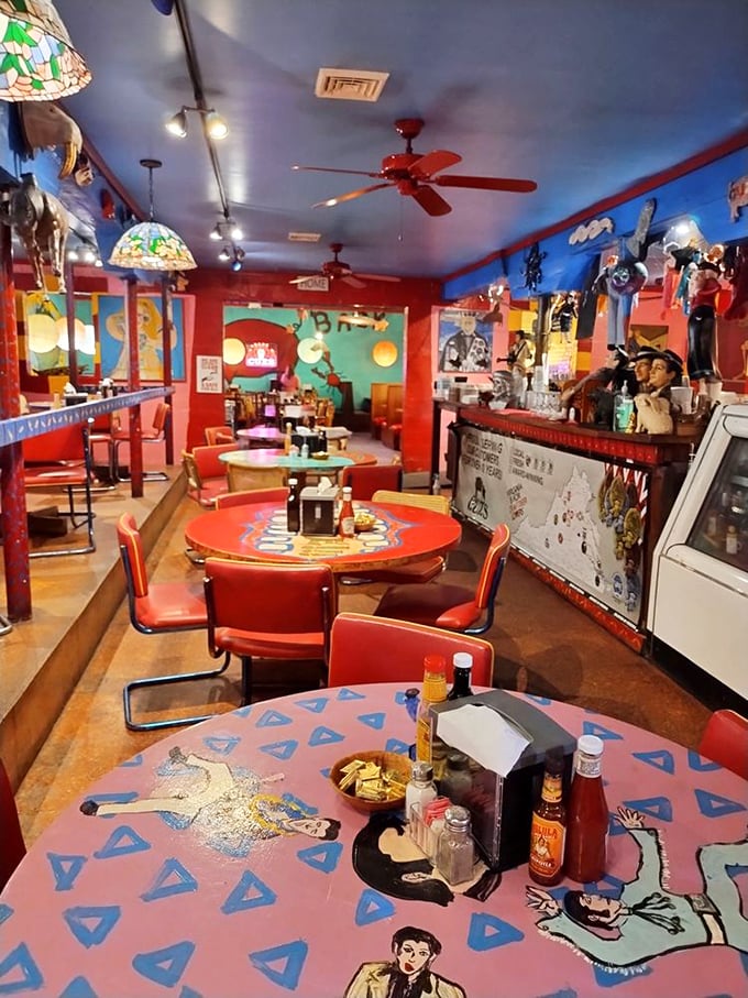 Dining at Cuz's feels like eating inside a Picasso painting that decided to open a steakhouse. Every surface tells a different story.