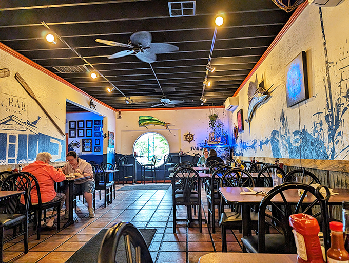 Inside, nautical charm meets cozy dining. The maritime murals and warm lighting create an atmosphere that whispers, "Slow down, savor, stay awhile."