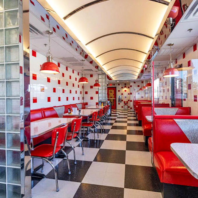 Step inside and the checkerboard floor leads your eye down a corridor of nostalgia, where red vinyl booths invite you to slide in and stay awhile.