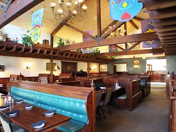 High wooden beams, turquoise booths, and warm lighting create that perfect sweet spot between "special occasion" and "come as you are" comfort.