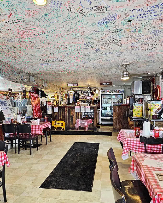 Where barbecue dreams are immortalized on the ceiling. Every signature tells a story of someone who found their happy place among the smoke and sauce.