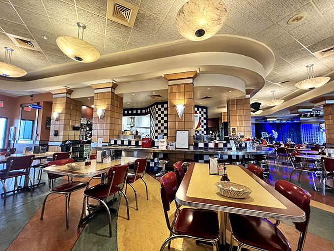 Inside, the classic black-and-white checkered motif creates the perfect backdrop for those red vinyl booths where memories are made over malts.