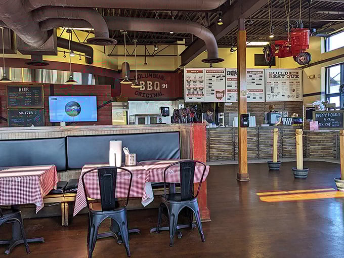 Industrial pipes meet homey checkered tablecloths in this barbecue sanctuary where serious smoking business happens while country comfort reigns supreme.