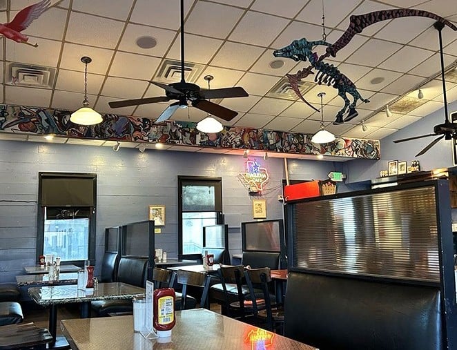 Dinosaur skeletons dance across the ceiling while vintage Texas memorabilia lines the walls &ndash; Austin's quirky soul captured perfectly in one cozy room.
