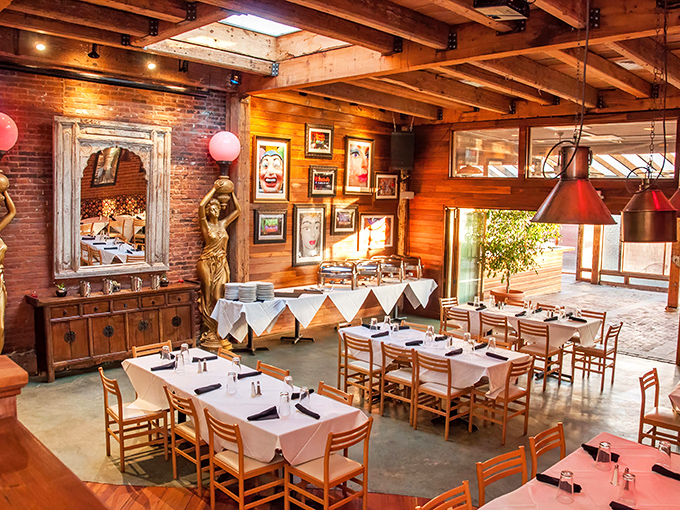 Exposed brick walls meet wooden beams in this dining room that strikes the perfect balance between "treat yourself" and "kick back and relax."