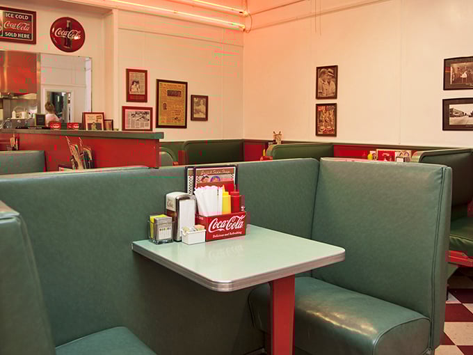 Mint green booths and vintage Coca-Cola signs set the stage for your 1950s dining adventure. Don Draper would approve.