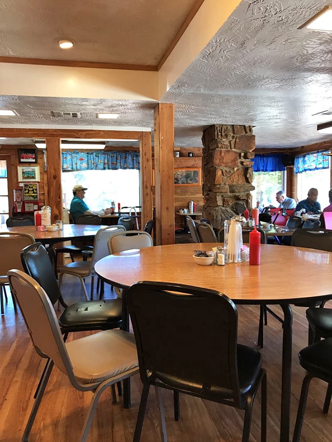 Wooden beams, stone fireplace, and comfortable seating create that "everybody knows your name" atmosphere where conversations flow as freely as the coffee.