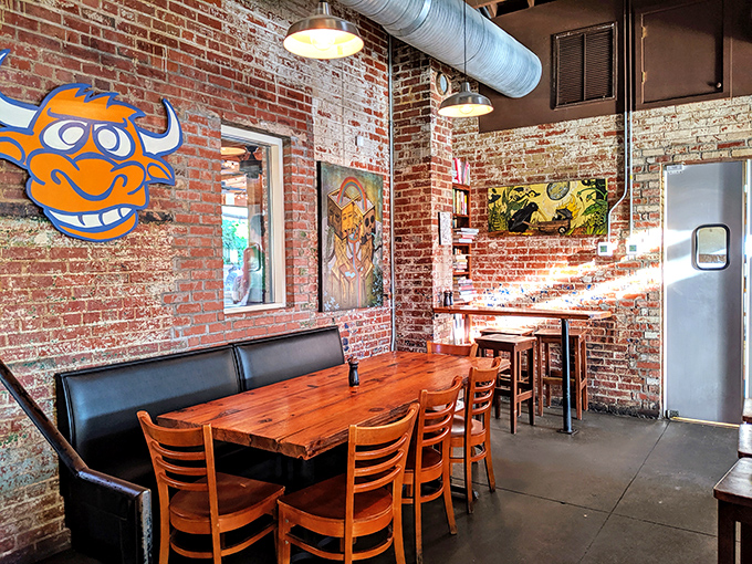 Inside, exposed brick walls tell stories while the quirky blue bull artwork stands guard over wooden tables. Industrial meets homey in this perfectly Durham space.