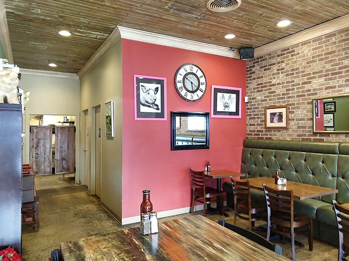 Exposed brick, salmon walls, and tufted booths create that perfect "I've found my new favorite spot" vibe. The clock suggests it's always time for barbecue.