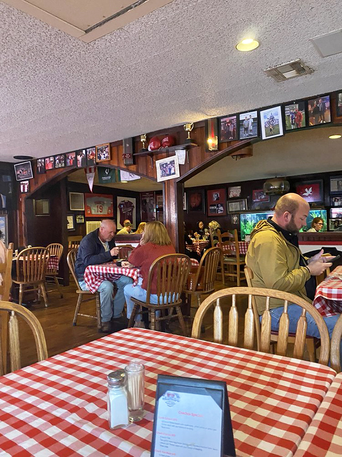 Inside Herman's, decades of Razorback memorabilia adorn wood-paneled walls while red-checkered tablecloths signal you've arrived at a place that takes meat seriously, not itself.