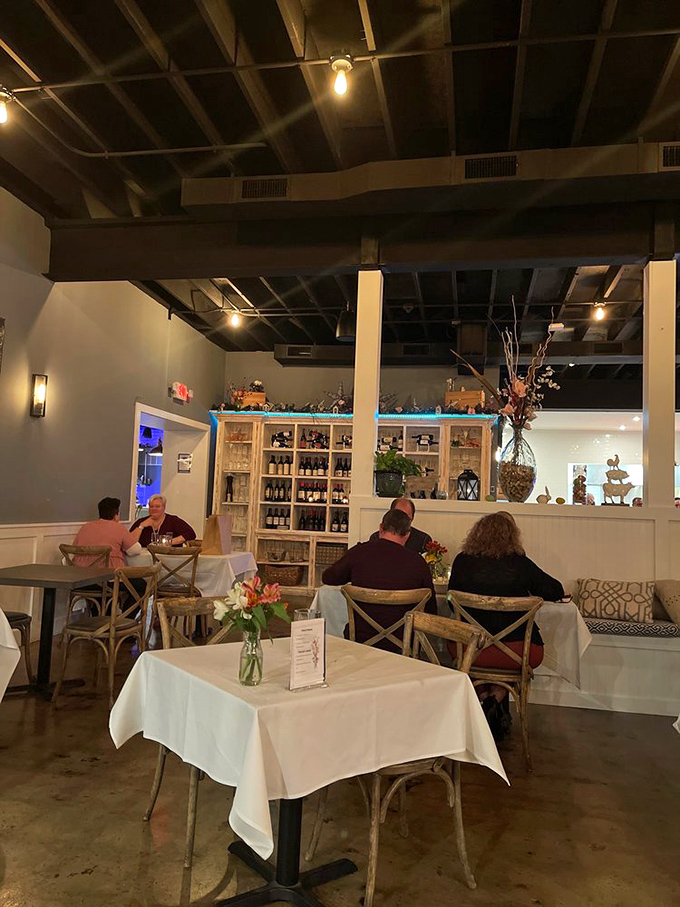Inside, exposed beams meet white tablecloths in that perfect sweet spot between "special occasion" and "I could get comfortable here." The wine display isn't showing off&mdash;it's just promising good decisions.