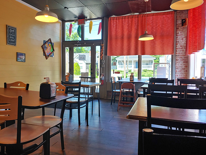 Simplicity reigns in this cozy dining space where red curtains and warm lighting create the perfect backdrop for New Mexican culinary magic.