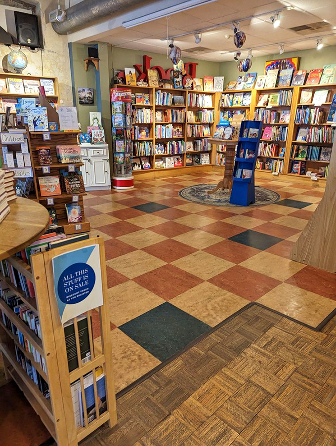A checkerboard floor leads you through literary wonderlands. Wooden shelves create cozy alcoves where time slows and your to-read list exponentially grows.