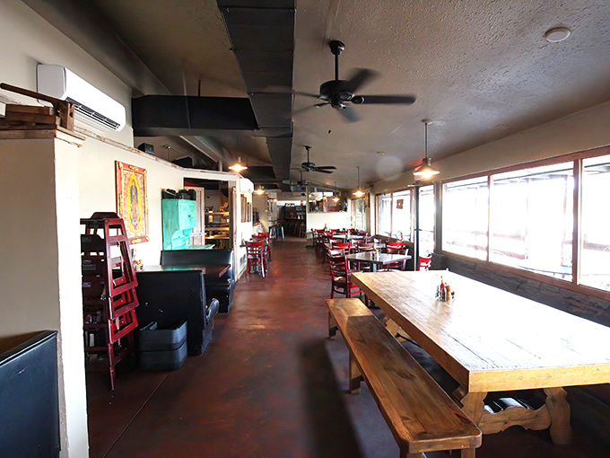 Long wooden tables invite communal dining while ceiling fans lazily spin overhead, creating the perfect backdrop for New Mexican culinary adventures.