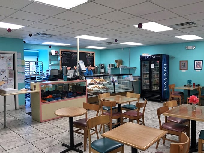 Bright turquoise walls and simple wooden tables create a cheerful backdrop for the serious business of donut appreciation. Like a cozy living room, if your living room smelled like heaven.