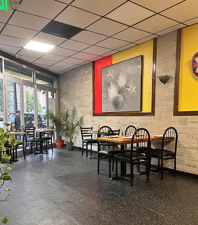 Yellow walls and simple furnishings create a warm, inviting space where the food, not the decor, takes center stage.