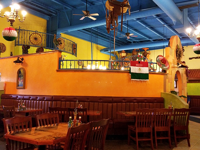 Step inside and the vibrant yellows and blues transport you straight to Mexico. That ceiling? Pure vacation vibes without the TSA pat-down.