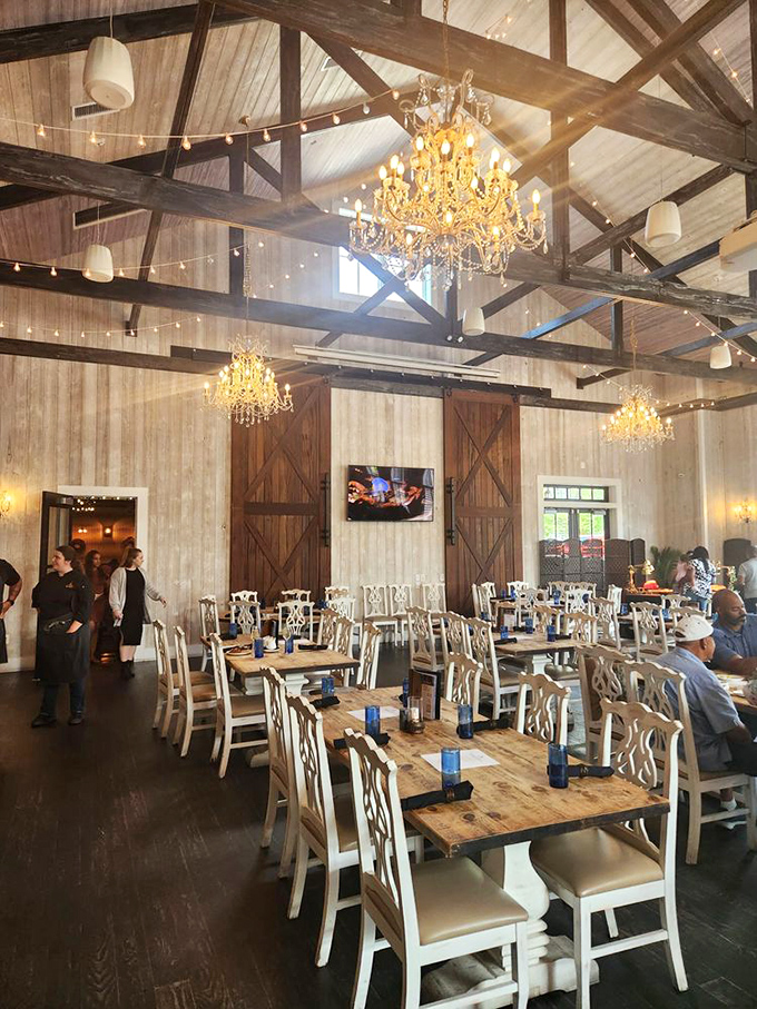 Rustic meets luxurious under soaring beams where crystal chandeliers transform a barn into a cathedral of gastronomy.