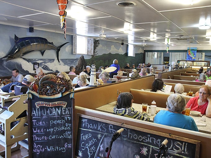 Where seafood dreams come true! The bustling interior of Twin Tops showcases its all-you-can-eat specials on the chalkboard while diners settle into comfortable booths.