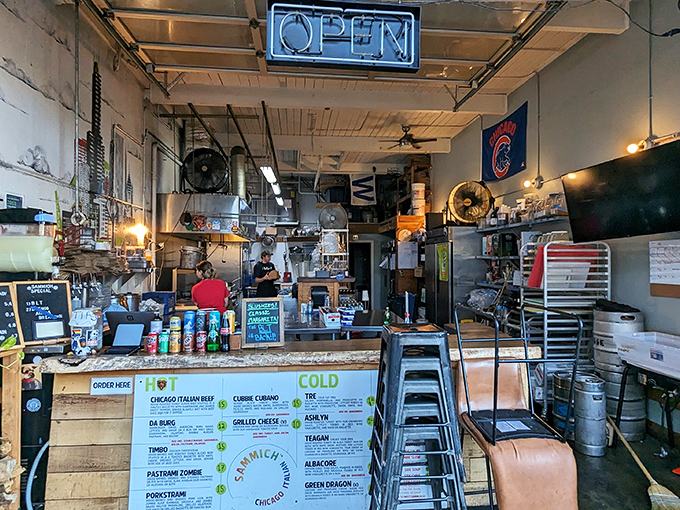 No-frills interior where culinary magic happens. The neon "OPEN" sign might as well say "PARADISE" for sandwich enthusiasts.