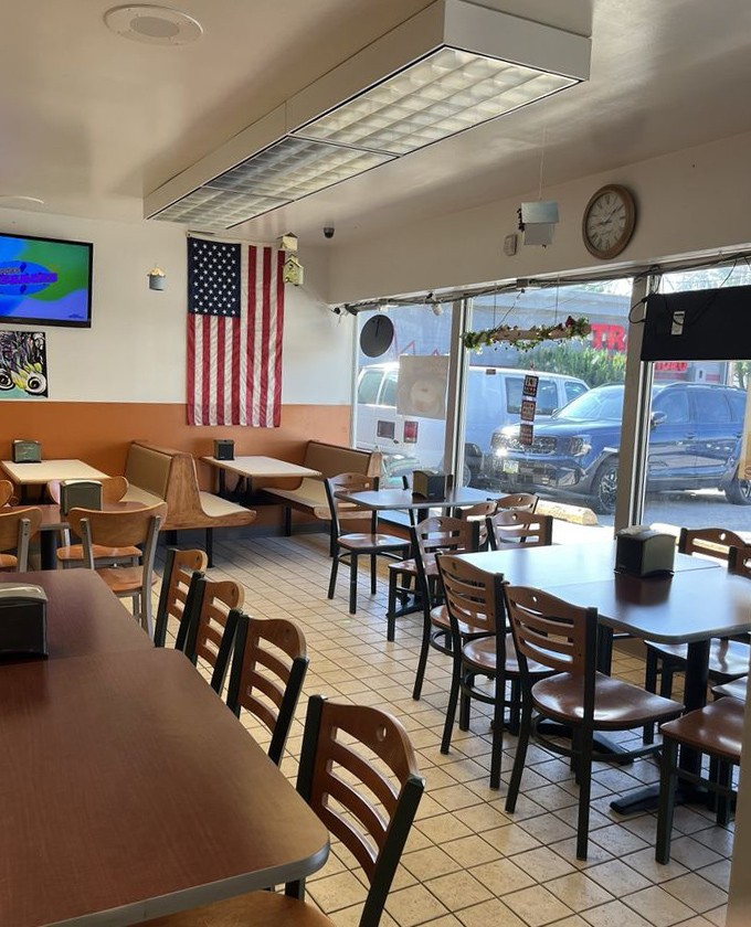 Simple tables, wooden chairs, and an American flag create the perfect no-frills backdrop for the main event—donuts that outshine any fancy décor a million-dollar designer could dream up.