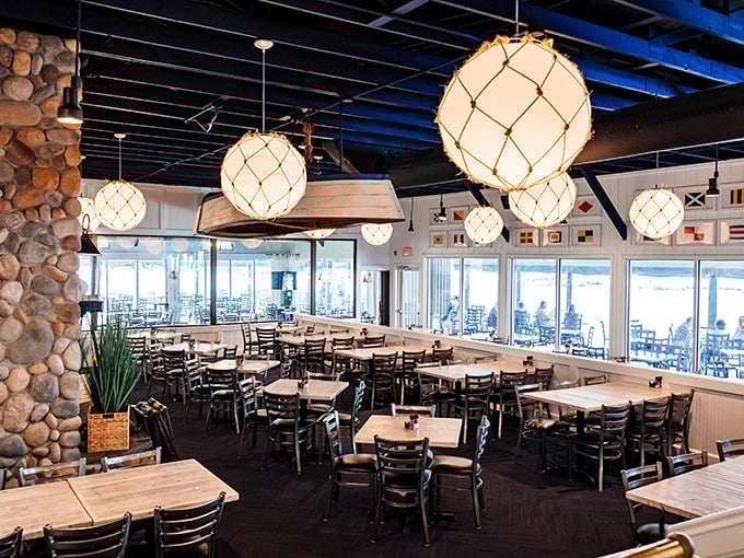 Nautical meets comfortable in this thoughtfully designed dining room. Those globe pendant lights cast the kind of glow that makes everyone look like they've just returned from vacation.