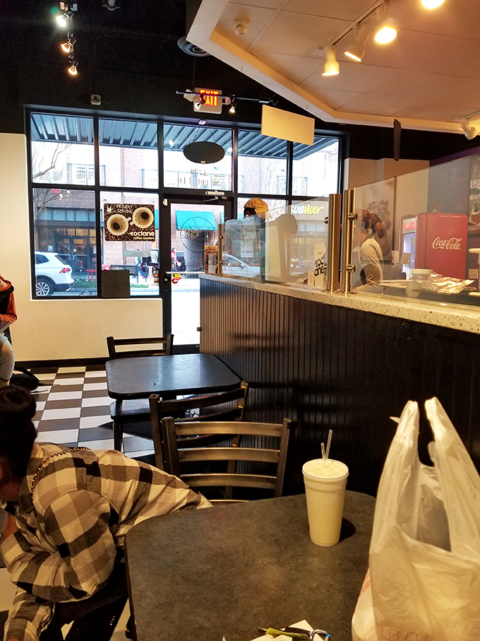 Classic black and white checkered floors set the stage for dessert drama. The minimalist interior lets the real stars&mdash;those magnificent rolls&mdash;take center stage.