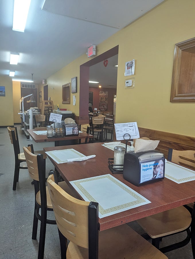 Inside, yellow walls and wooden tables create that perfect small-town atmosphere where conversations flow as freely as the coffee.